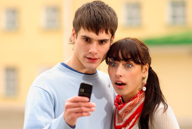 Two Look at Cellular Telephone Stock Image - Image of human, family ...