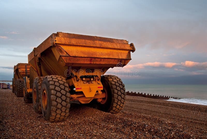 Two Lorries on a Pebble Beach Stock Image - Image of site, evening ...