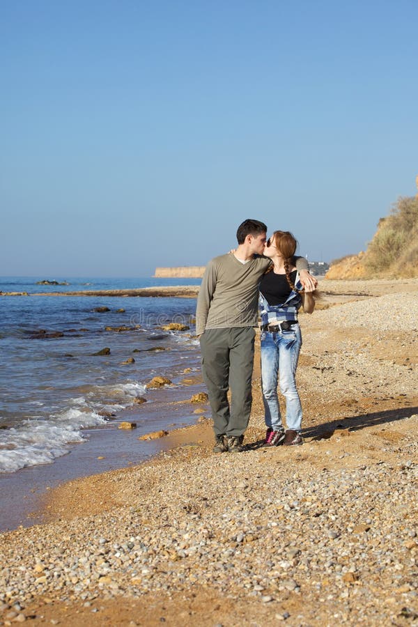 Two lovers on the beach stock image. Image of sunlight - 17037971
