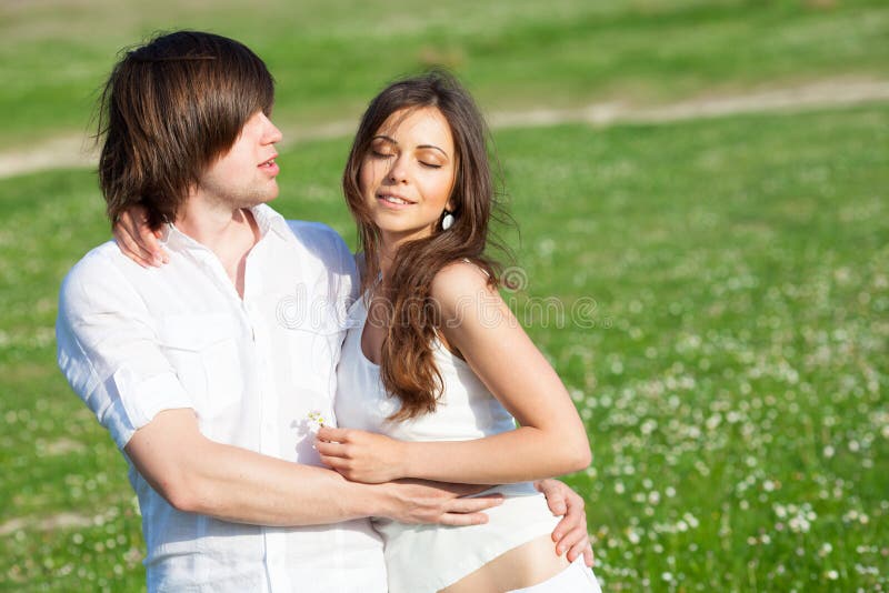 Two lovers on the grass stock image. Image of blue, couple - 62530453