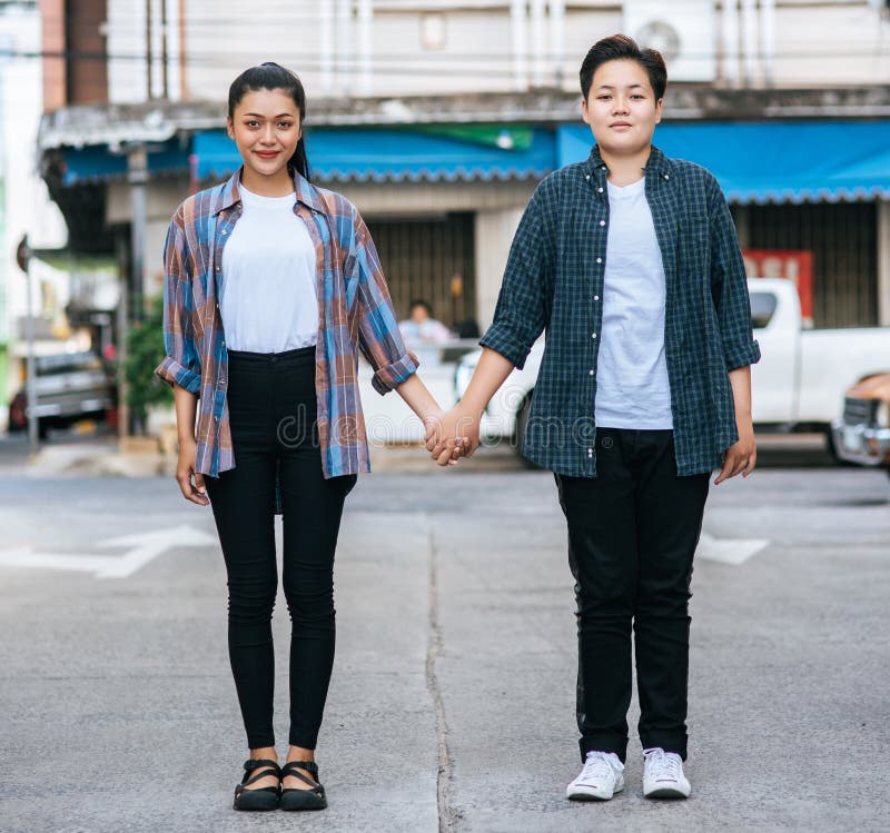 Two Loving Women Standing and Holding Hands on the Street Stock Image ...