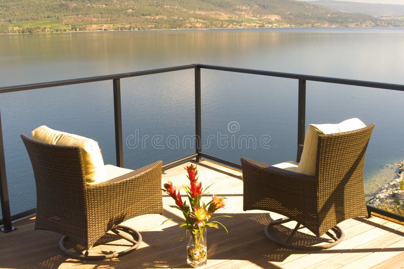 Two Luxurious Chairs on a Lakefront Sun Deck Stock Photo - Image of ...
