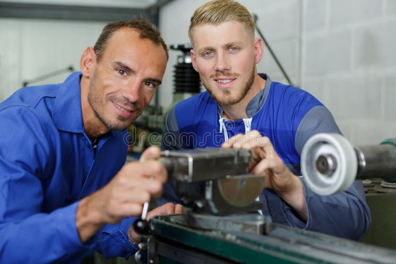 Two Machinists at Work Posing Stock Image - Image of machinist, bore ...