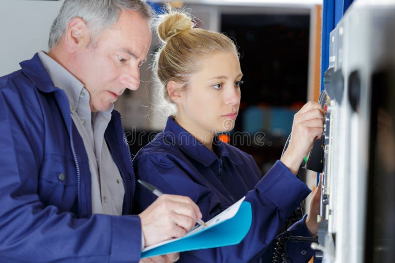 Two Machinists Working on Machine Stock Photo - Image of laborer ...