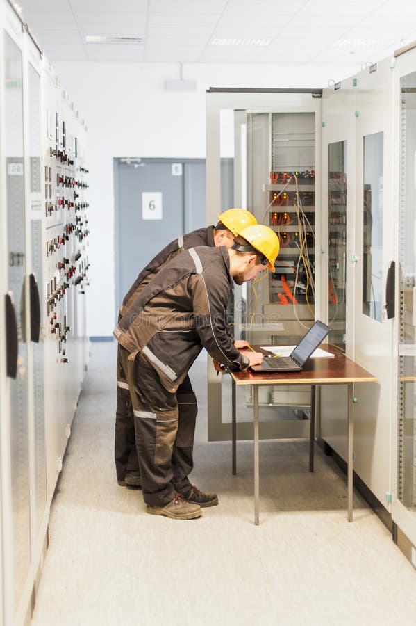 Two Maintenance Engineers Inspect Relay Protection System with L Stock ...
