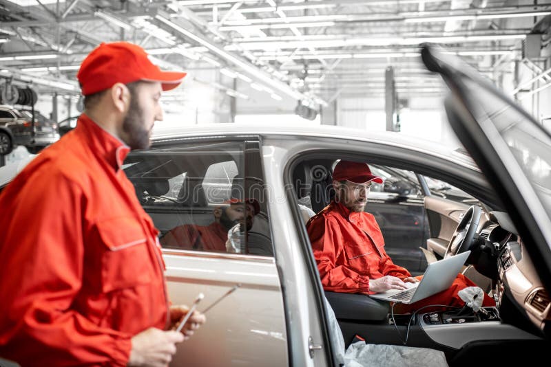 Auto Mechanics Diagnosing Car with Computer Stock Image - Image of ...
