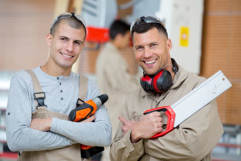 Two male carpenters posing stock image. Image of concept - 261156223