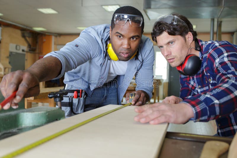 Two Male Carpenters Working Together in Workshop Stock Image - Image of woodwork, goggles: 246349405