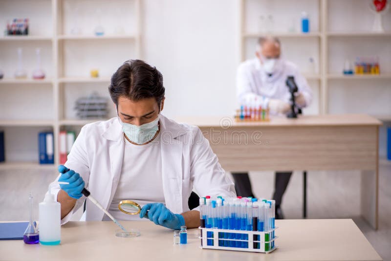 Two Male Chemist Working at the Lab Stock Image - Image of looking ...