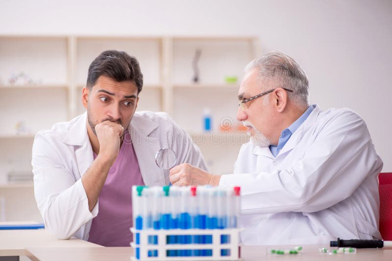 Two Male Chemists Working at the Lab Stock Photo - Image of discussing ...