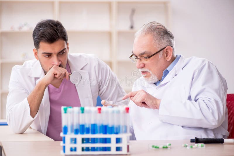 Two Male Chemists Working at the Lab Stock Image - Image of discussing ...