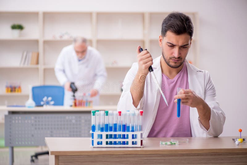 Two Male Chemists Working at the Lab Stock Photo - Image of solution ...