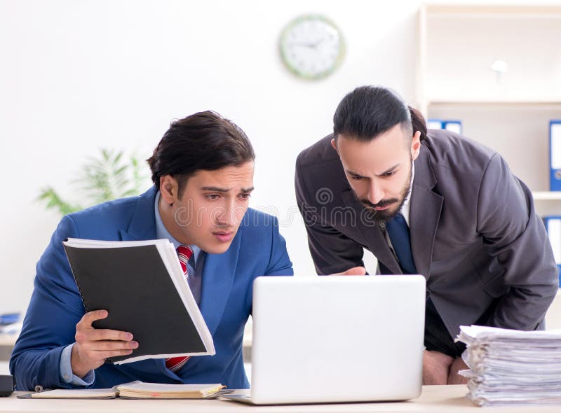Two Male Colleagues in the Office Stock Photo - Image of papers ...