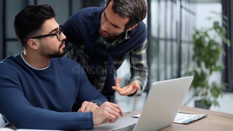Two Male Colleagues are Talking at the Table in the Office. Stock Photo ...