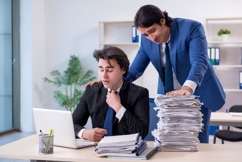 Two Male Colleagues Unhappy with Excessive Work Stock Image - Image of ...