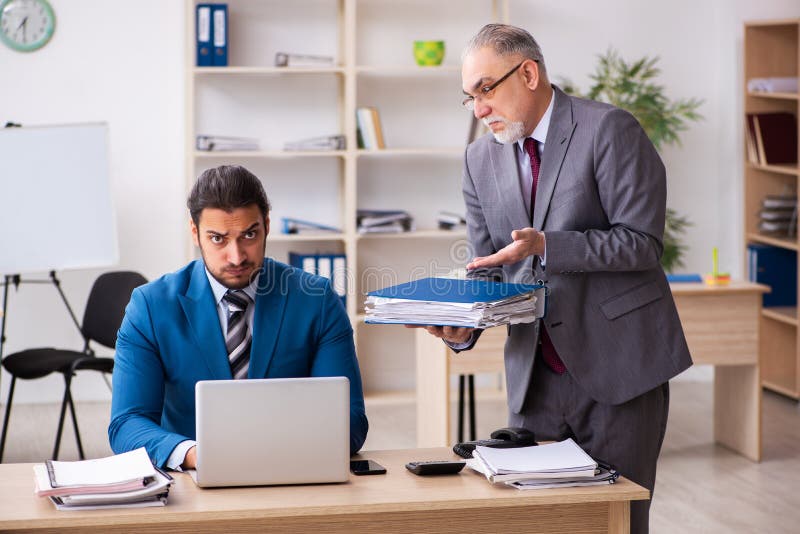Two Male Colleagues Working in the Office Stock Photo - Image of papers ...