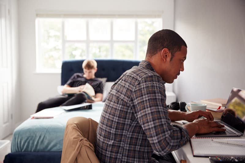 Two Male College Students in Shared House Bedroom Studying Together ...