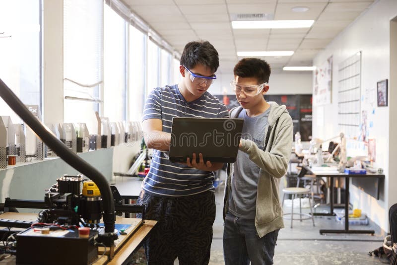 Two Male College Students Using Laptop Computer in Science Robotics or ...