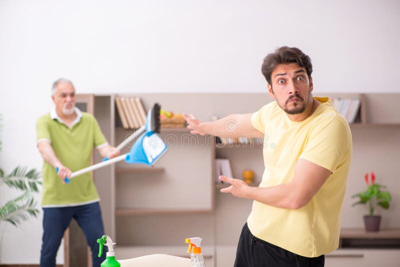 Two Male Contractors Cleaning the House Stock Photo - Image of father ...