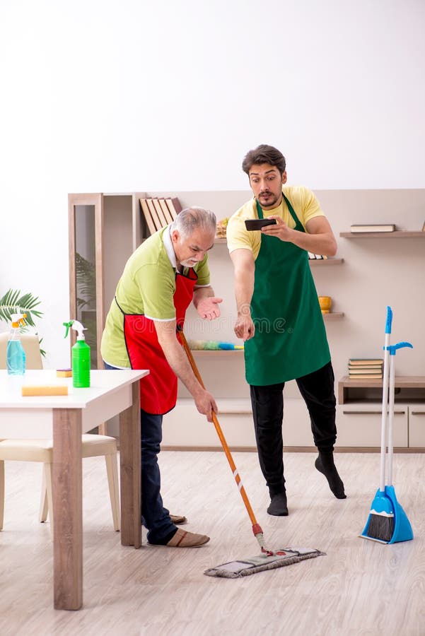 Two Male Contractors Cleaning the House Stock Photo - Image of teamwork ...