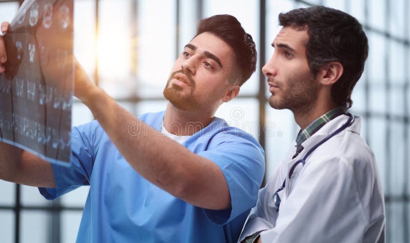 Two Male Doctors Looking at Brain X-ray Stock Photo - Image of ...
