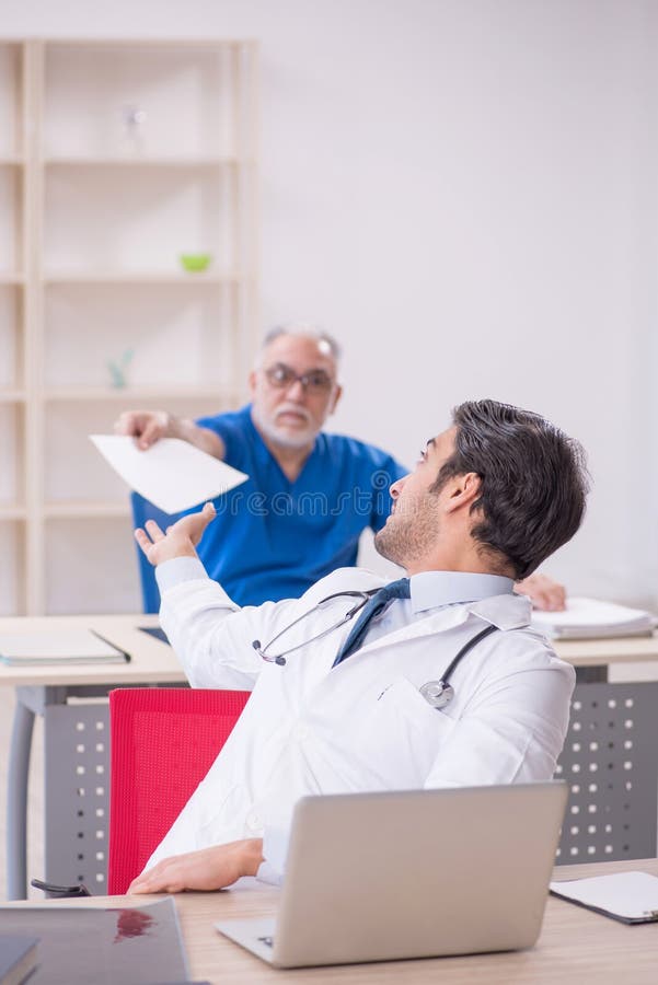 Two Male Doctors Working in the Clinic Stock Image - Image of ...