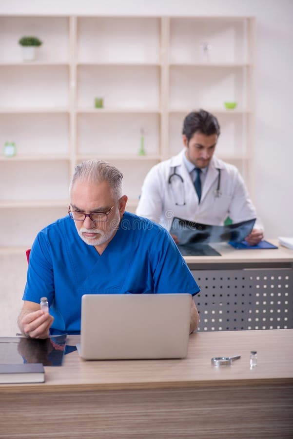 Two Male Doctors Working in the Clinic Stock Photo - Image of bottle ...