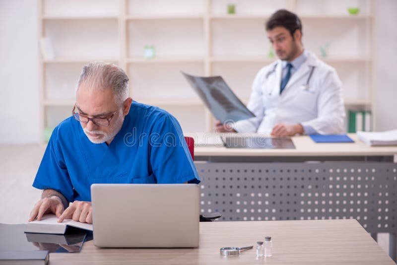 Two Male Doctors Working in the Clinic Stock Image - Image of treatment ...