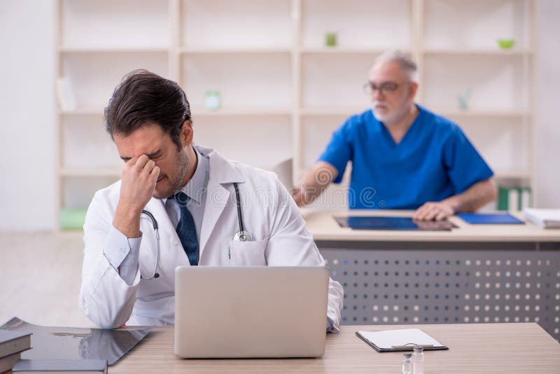 Two Male Doctors Working in the Clinic Stock Image - Image of treatment ...