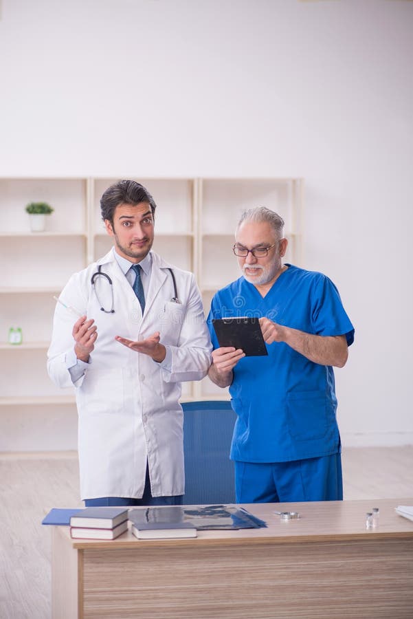 Two Male Doctors Working in the Clinic Stock Image - Image of treatment ...