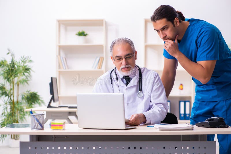 Two Male Doctors Working in the Clinic Stock Image - Image of colleague ...