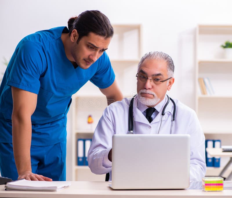 Two Male Doctors Working in the Clinic Stock Image - Image of doctors ...