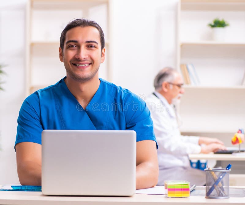 Two Male Doctors Working in the Clinic Stock Image - Image of laptop ...