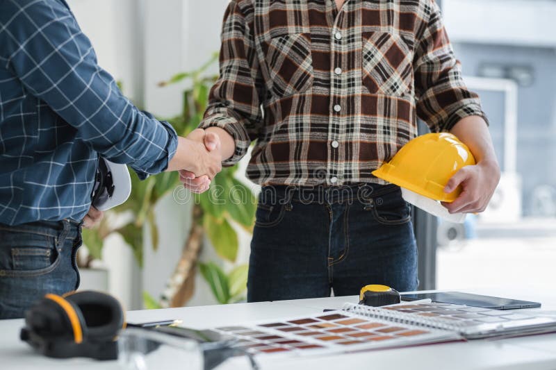 Two Male Engineers Shaking Hands in a Modern Office Environment ...