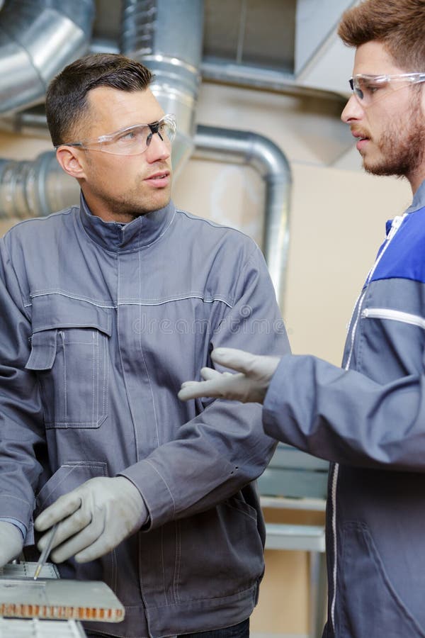 Discussion on Factory Floor Stock Photo - Image of inspector ...