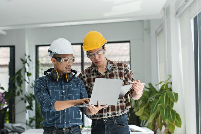 Engineers Discussing Construction Plans, Holding Blueprints, Wearing ...