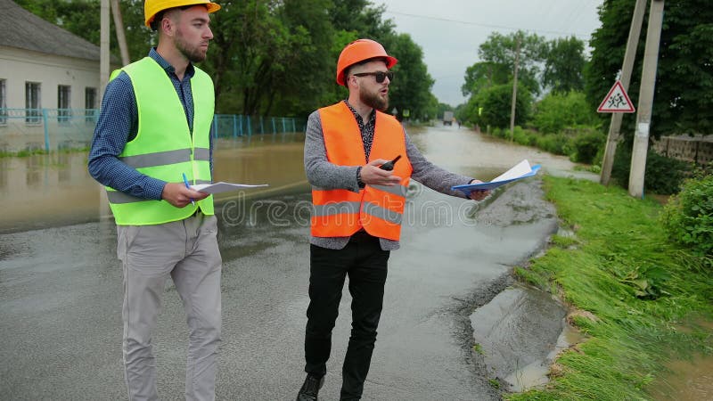 Male Engineers Solve Flood Problem. Devastation Wrought after Massive ...