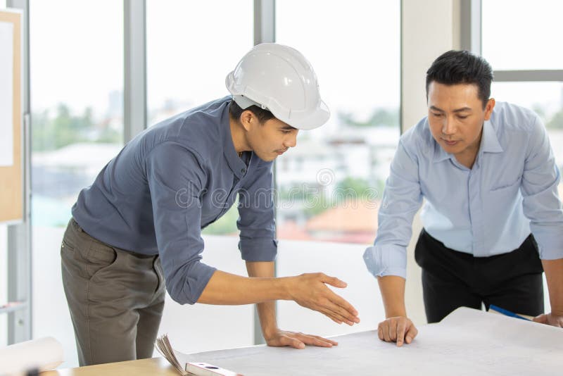 Two Male Engineers Team Talking and Discussing a Home Plan for a ...