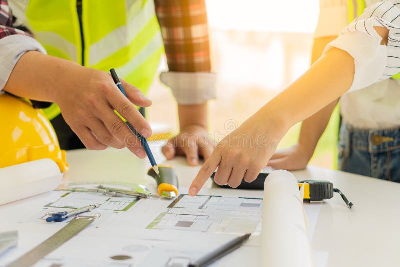 Two Male and Female Engineers Working on Blueprints for the Project ...