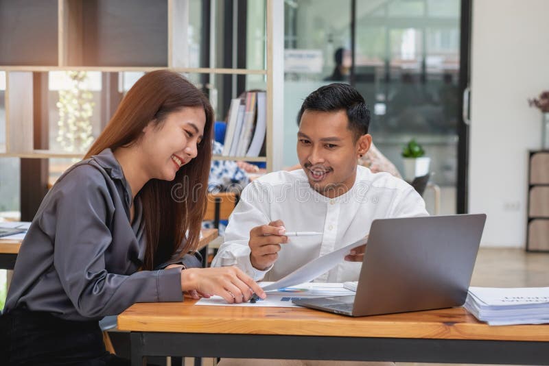 Two Male and Female Marketers Use Company Documents and Use Laptop ...