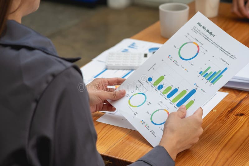 Two Male and Female Marketers Use Company Documents and Use Laptop ...