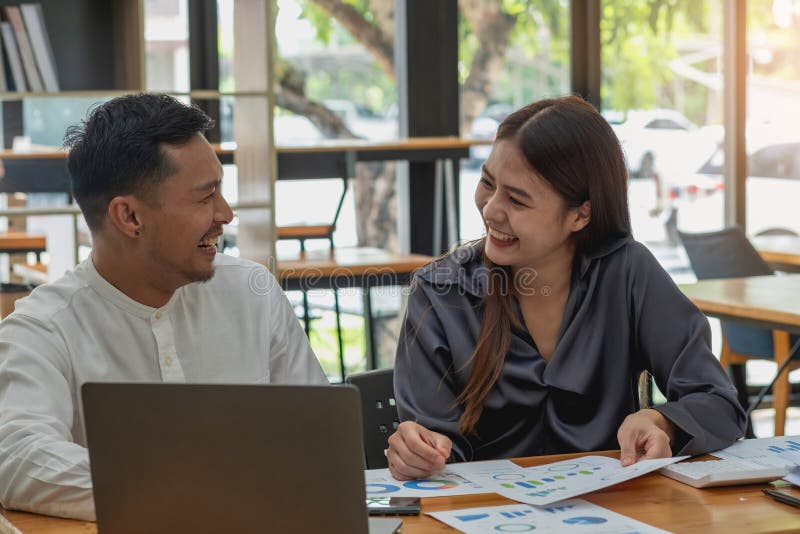 Two Male and Female Marketers Use Company Documents and Use Laptop ...