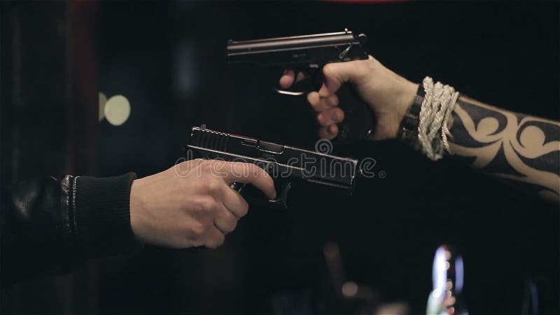 Two Male Hands with Guns Take Aim at Each Other. Close Up Stock Video ...