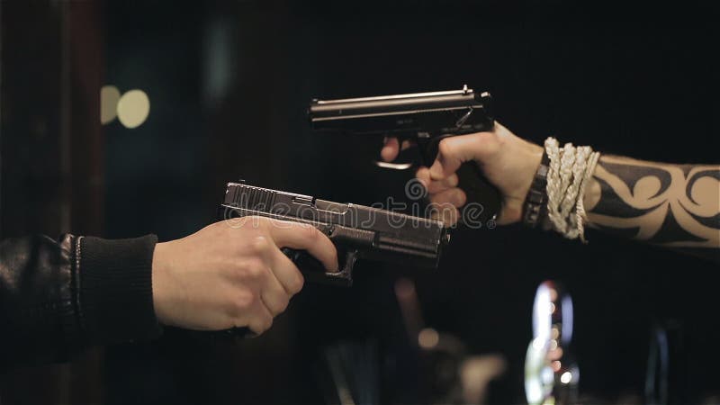 Two Male Hands with Guns Take Aim at Each Other. Close Up Stock Video ...