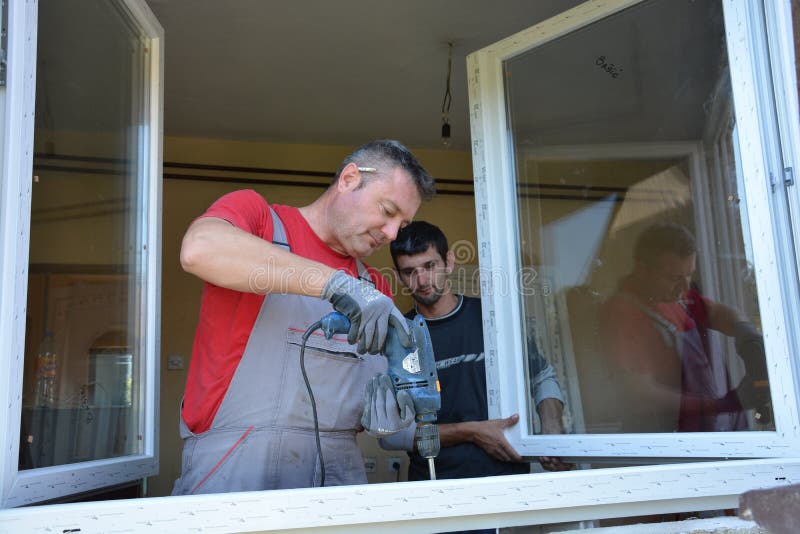 Construction Workers Installing Plastic Window Stock Photo - Image of ...