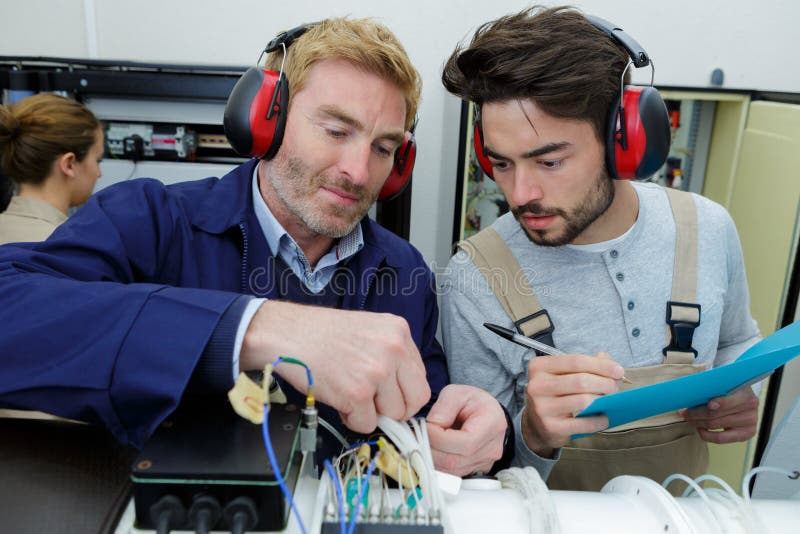 Two Male Masters Work in Workshop with Electronics Stock Photo - Image ...
