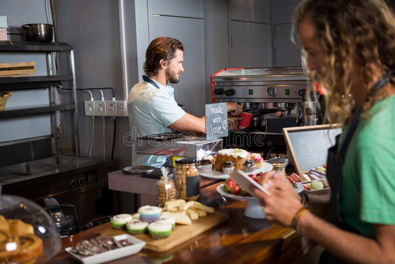 Two Male Staff Working at Counter Stock Photo - Image of coworker ...