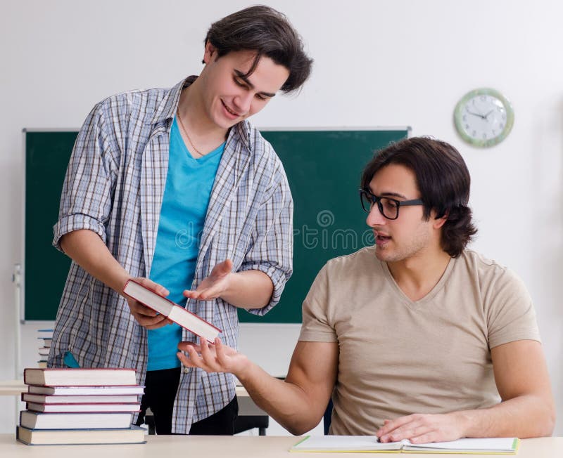 Two Male Students in the Classroom Stock Image - Image of green, book ...