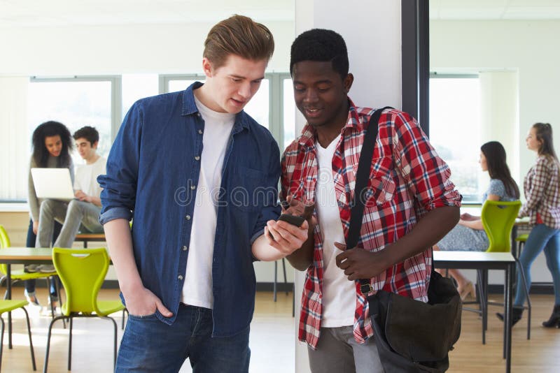 Two Male Students Looking at Mobile Phone in Classroom Stock Image ...
