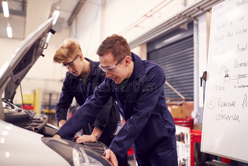 Two Male Students Studying for Auto Mechanic Apprenticeship at College ...
